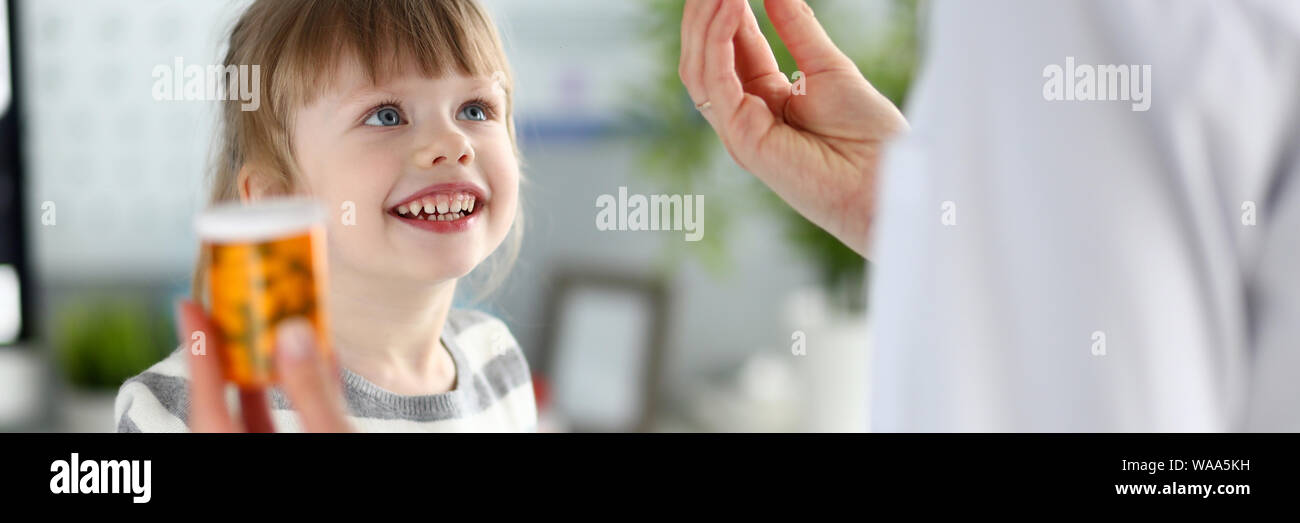 Cute little girl at doctor reception getting medications prescription ...