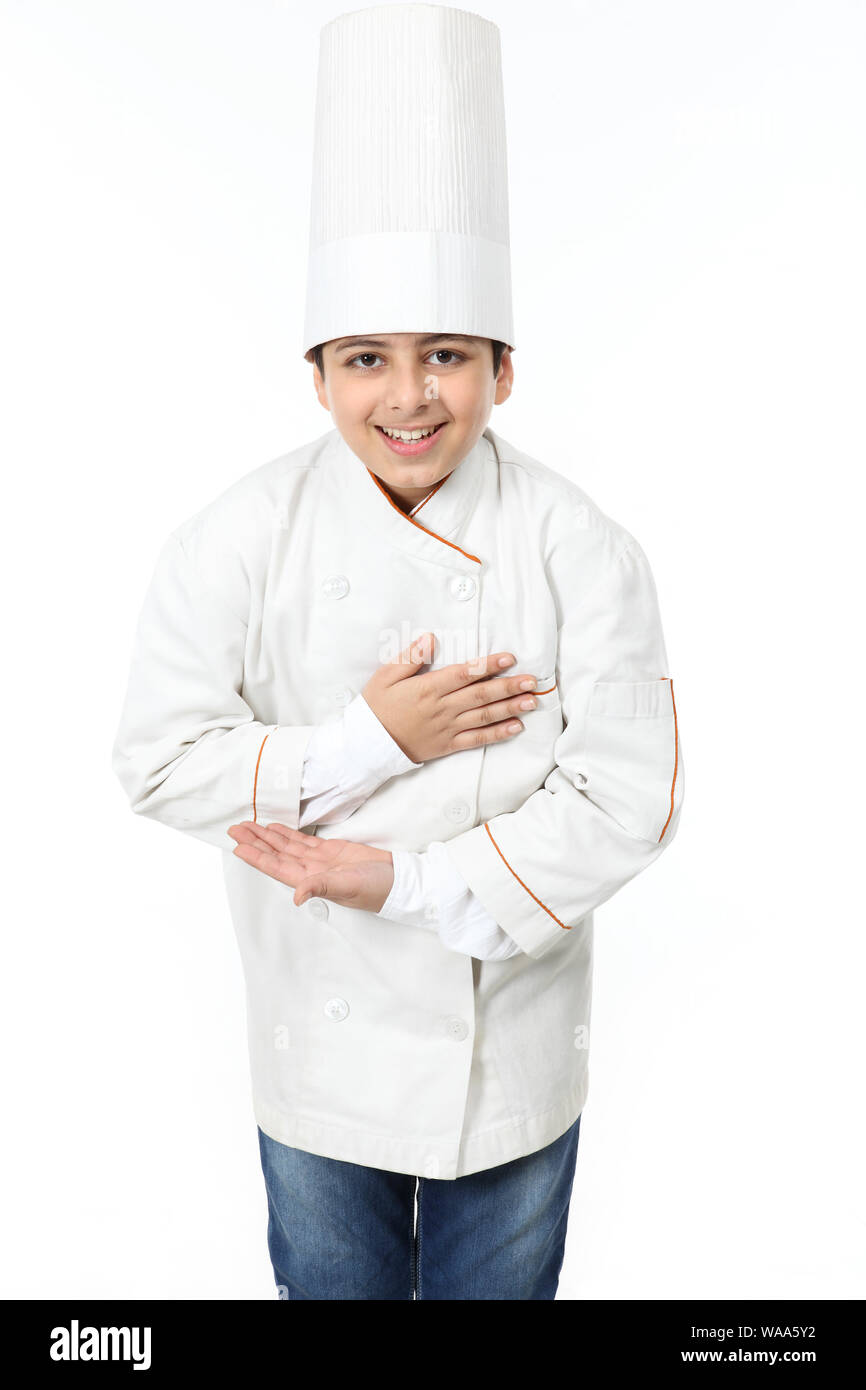 Boy pretending to be a chef and welcoming Stock Photo - Alamy