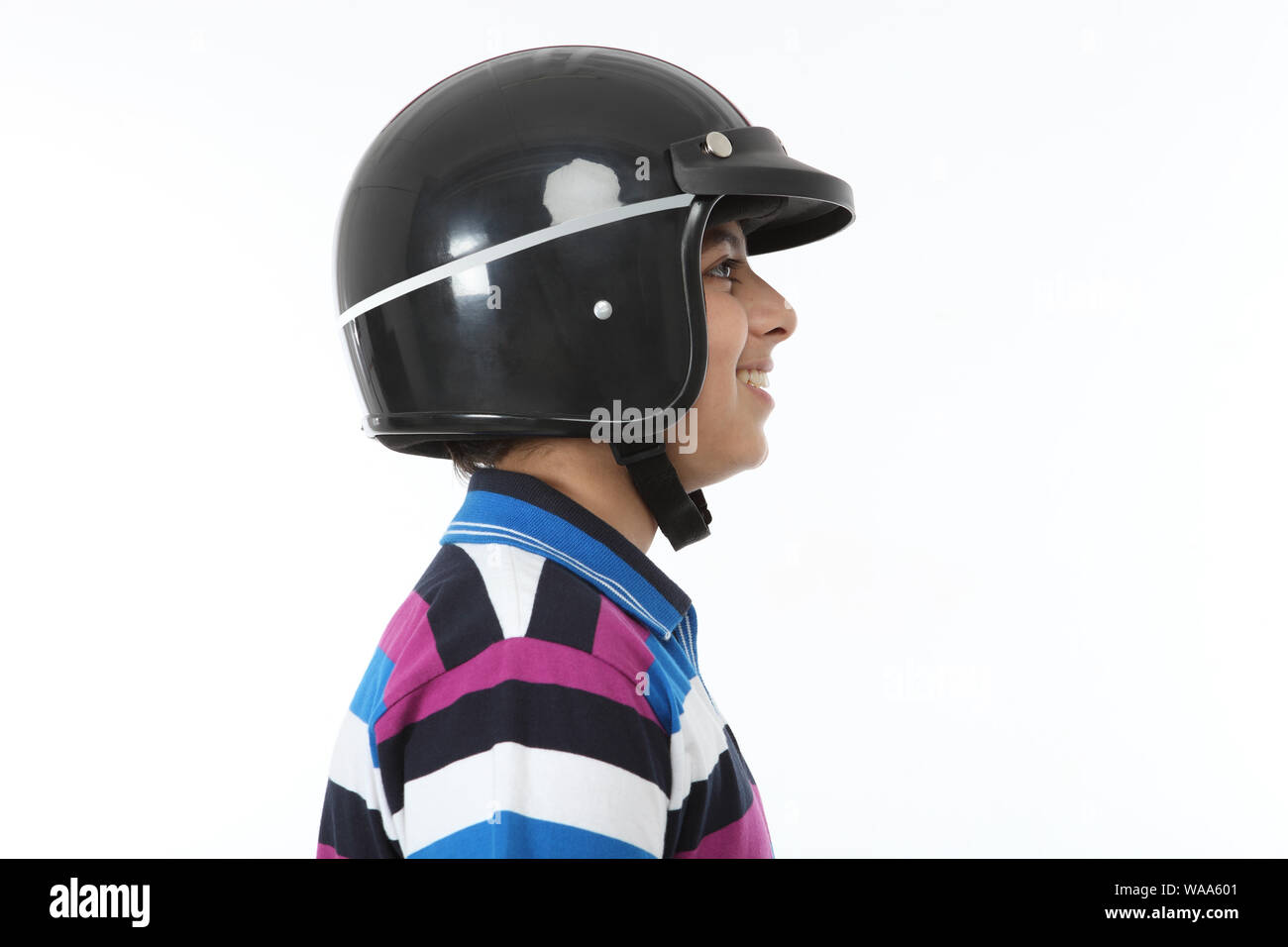 Side profile of a boy wearing helmet and smiling Stock Photo - Alamy