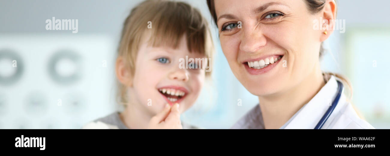 Smiling cute little patient interacting with female doctor Stock Photo ...