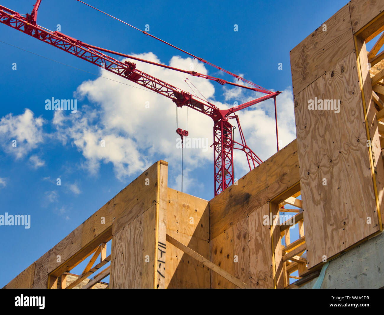 Tower sky crane over wooden building Stock Photo - Alamy