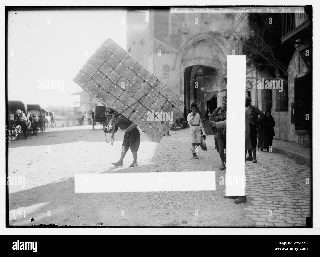 Porter carrying heavy load Black and White Stock Photos & Images - Alamy