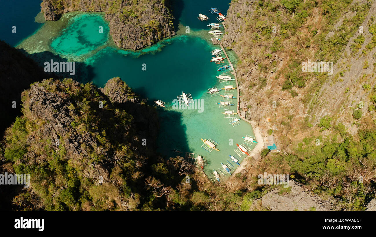 Aerial view tourist boats in lagoons. Kayangan Lake. lagoons, mountains ...