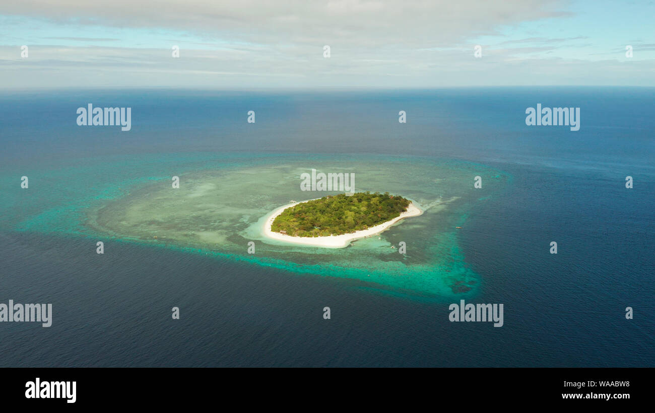 Tropical island Mantigue and sandy beach surrounded by atoll coral reef ...