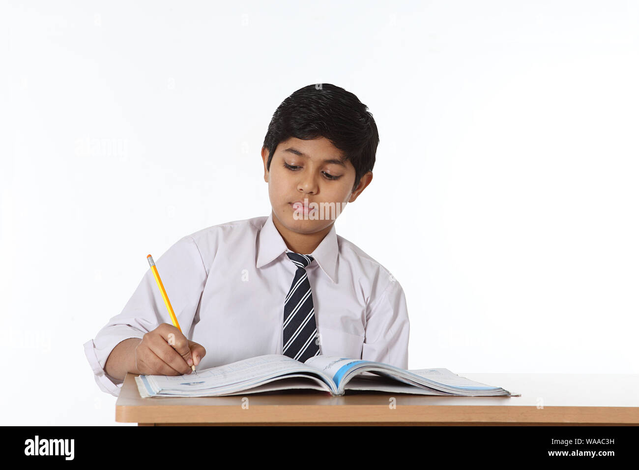 Schoolboy studying in a classroom Stock Photo - Alamy