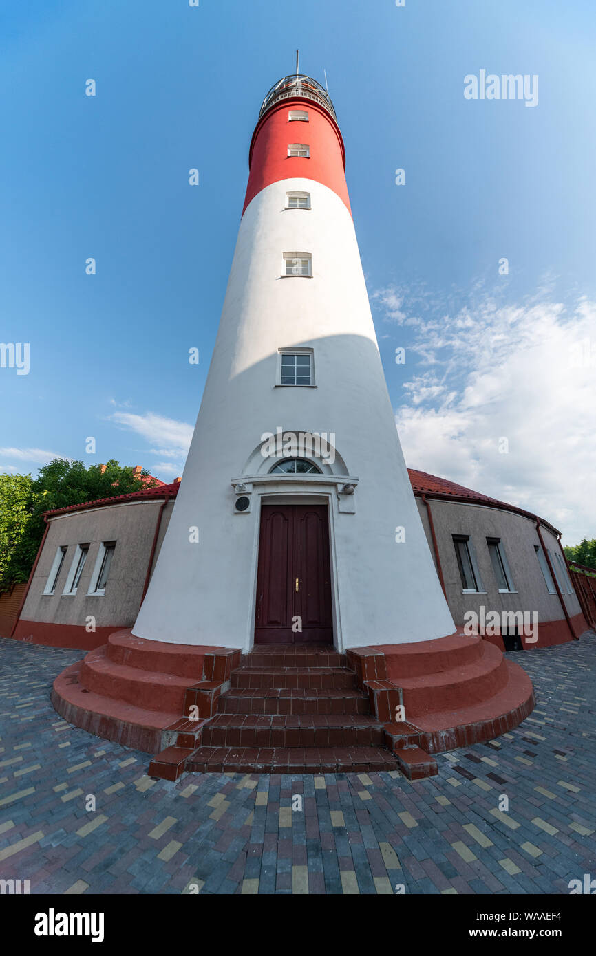 Baltic lighthouse, red white colors, bottom view. Most western russian ...