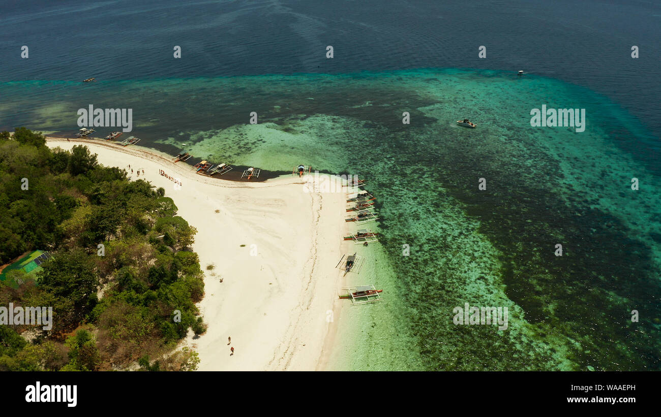 Tropical island in the blue sea with coral reef, top view. Small island ...
