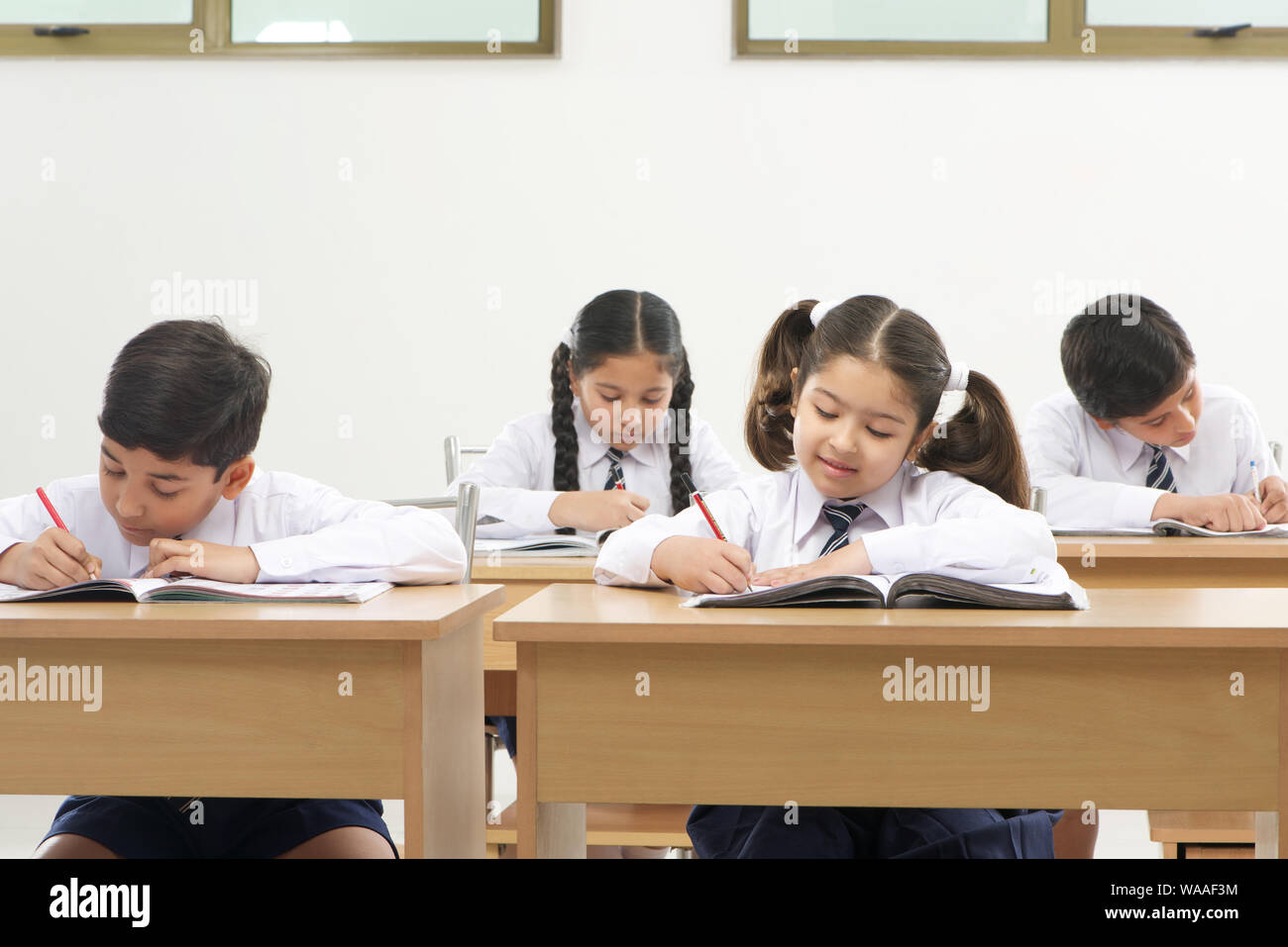 School children studying in a classroom Stock Photo - Alamy