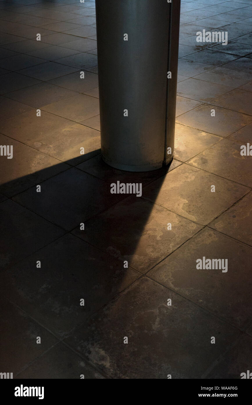 A Single Pillar Casting A Shadow Onto A Paved Floor Stock Photo - Alamy