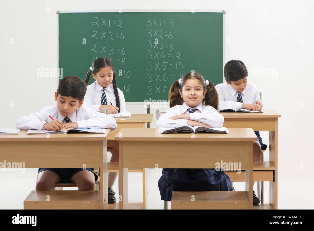 School children studying in a classroom Stock Photo - Alamy