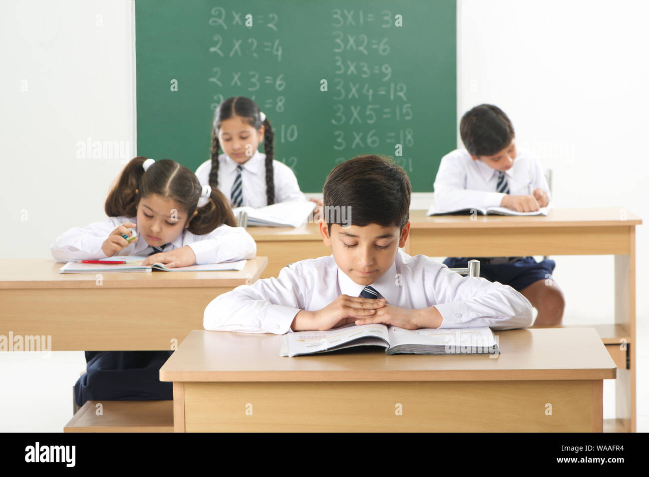 School children studying in a classroom Stock Photo - Alamy