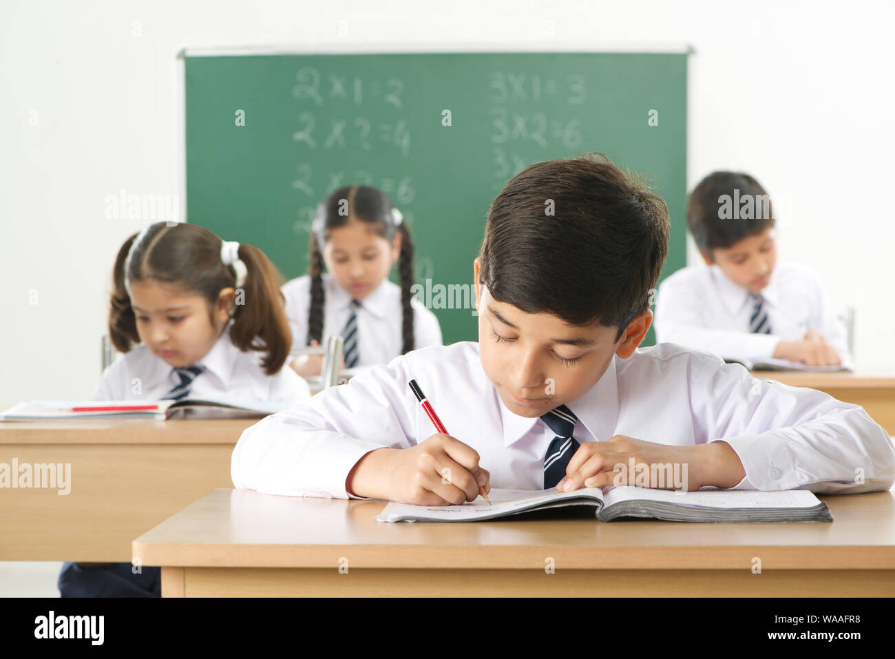 School children studying in a classroom Stock Photo - Alamy