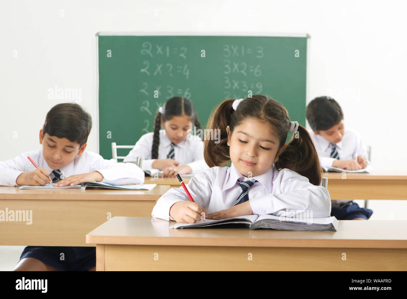 School children studying in a classroom Stock Photo - Alamy