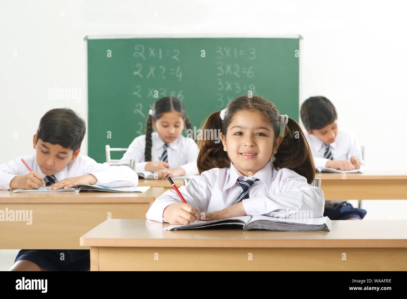 School children studying in a classroom Stock Photo - Alamy