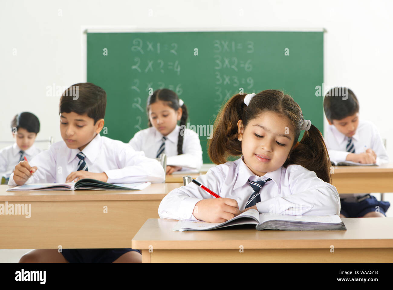 School children studying in a classroom Stock Photo - Alamy