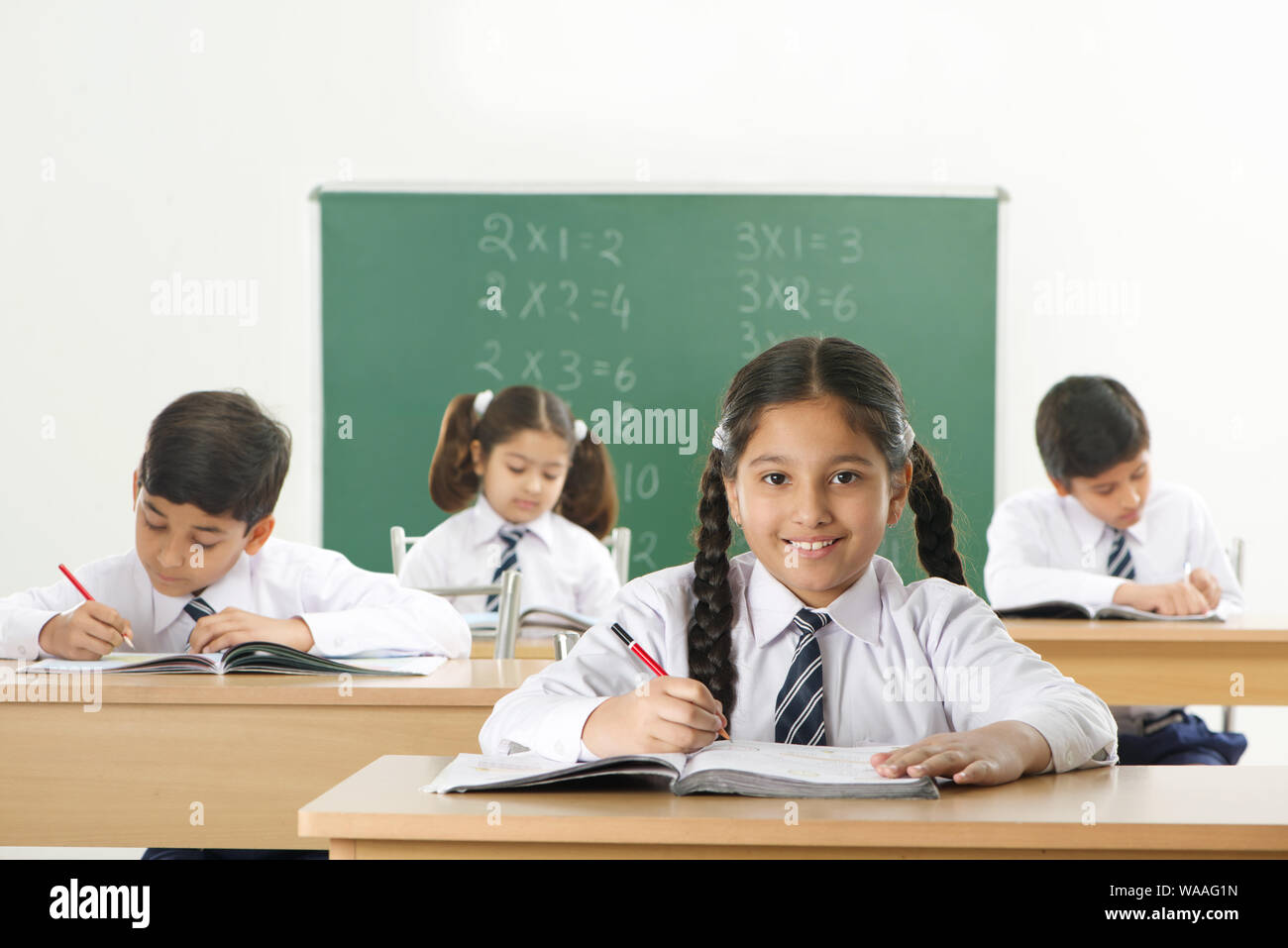 School children studying in a classroom Stock Photo - Alamy