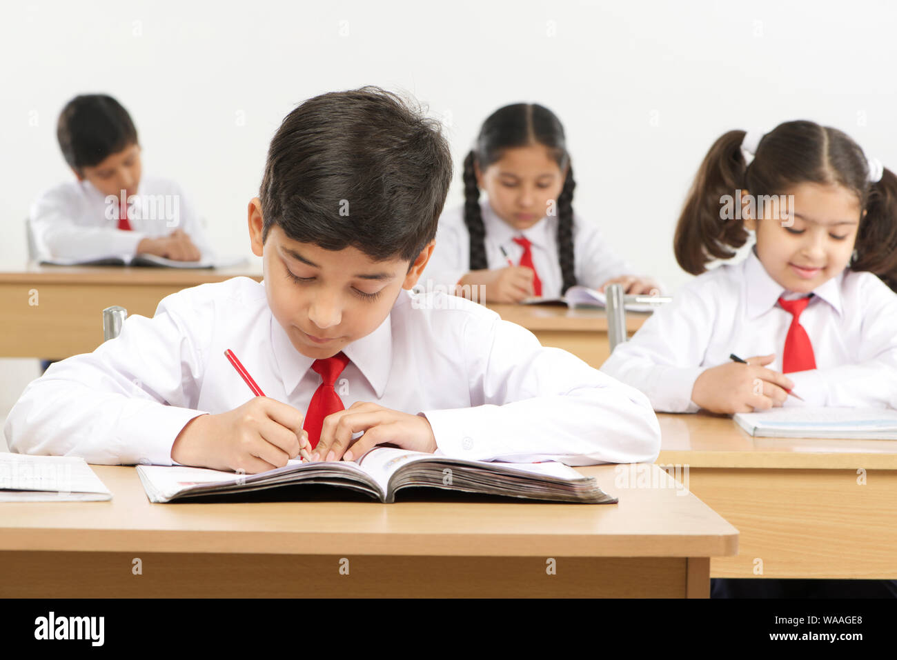 School children studying in a classroom Stock Photo - Alamy