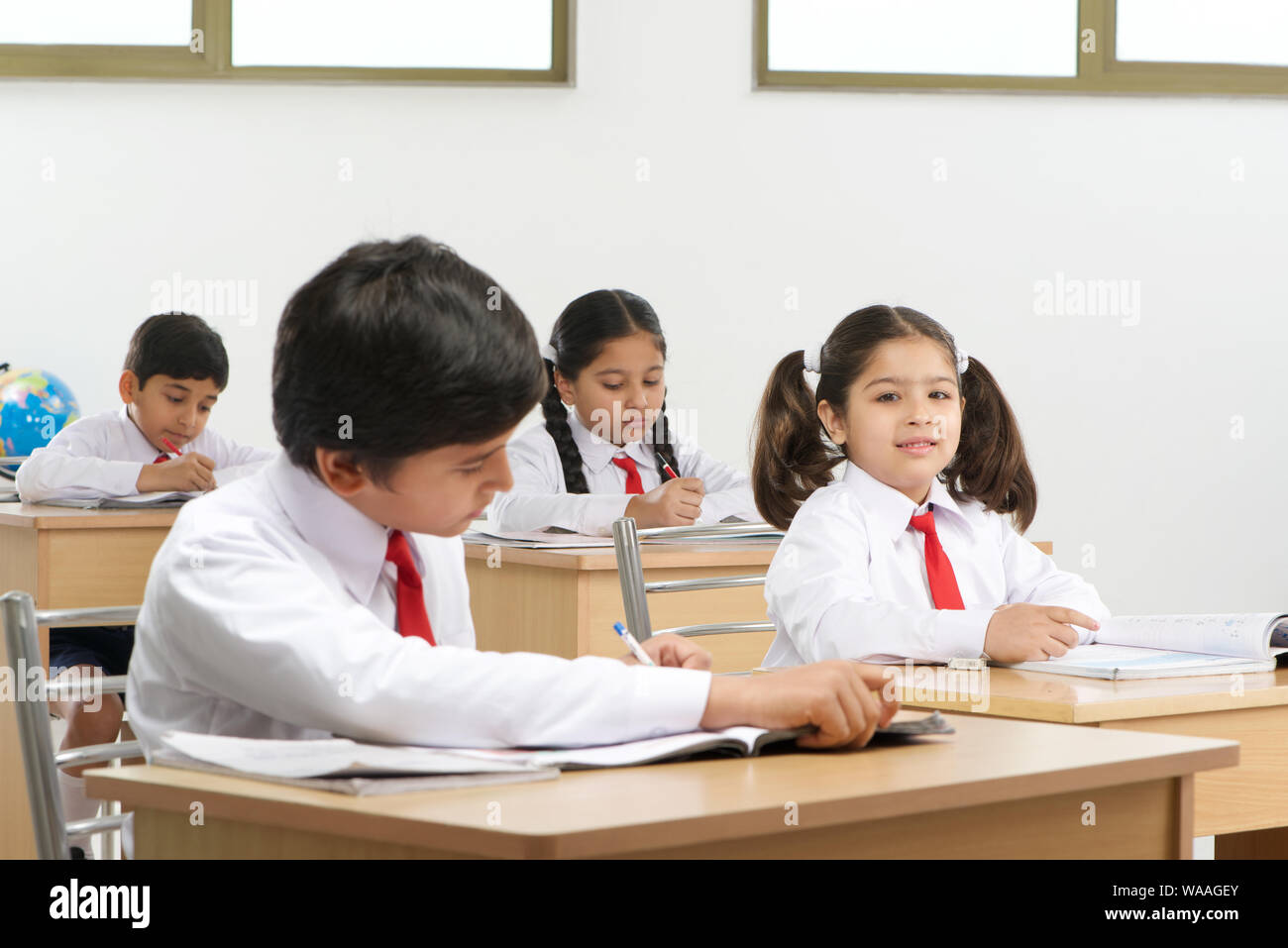 School children studying in a classroom Stock Photo - Alamy