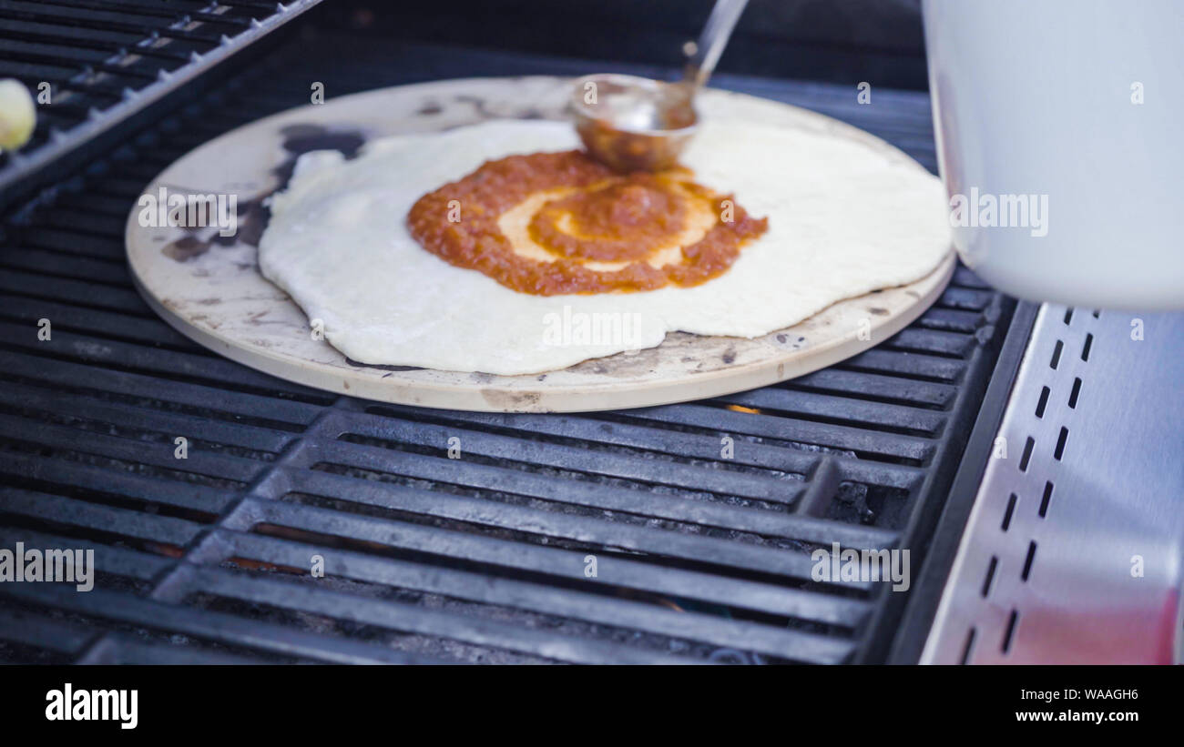 Cooking pizza on outdoor gas grill Stock Photo - Alamy