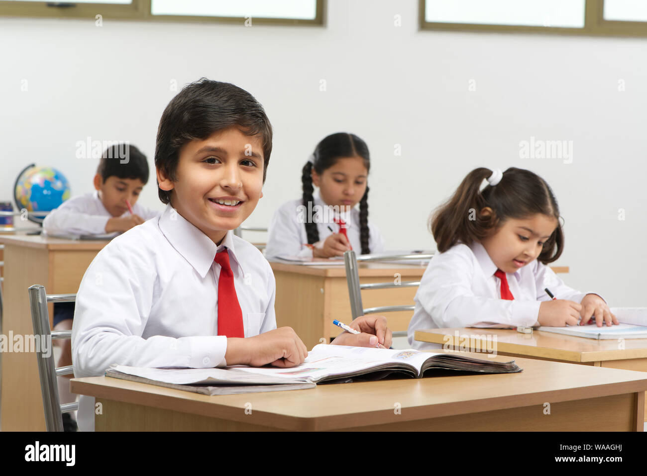 School children studying in a classroom Stock Photo - Alamy
