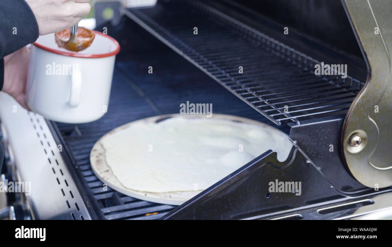 Cooking pizza on outdoor gas grill Stock Photo - Alamy