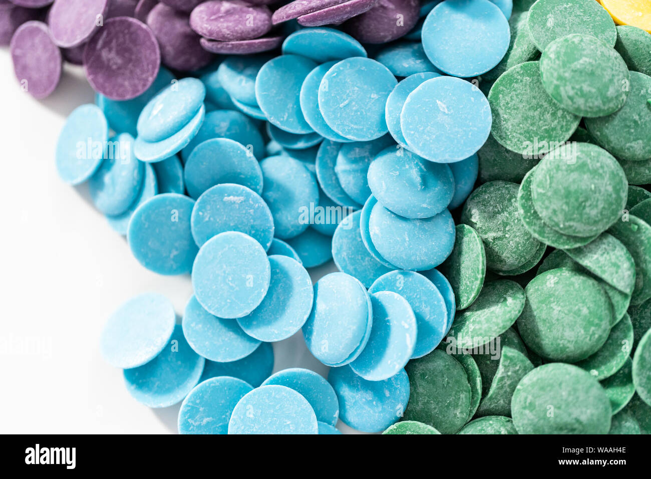 Rainbow colors of round chocolate chips for melting chocolate shapes on ...