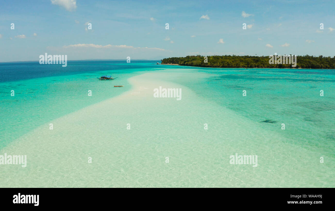 Seascape with a beautiful beach and tropical island surrounded by a ...