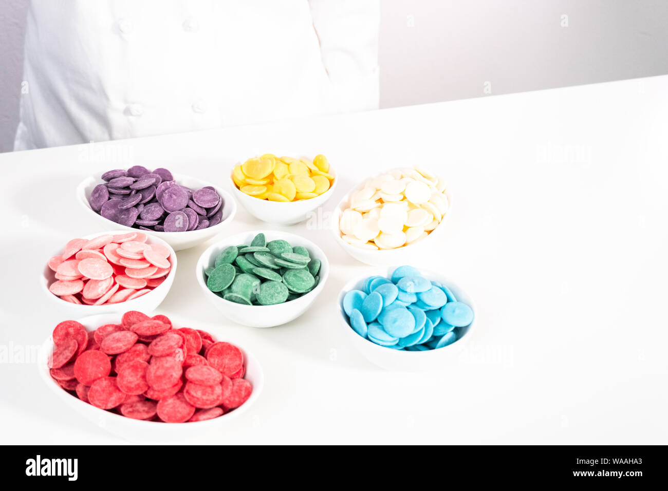 Pink round chocolate chips for melting chocolate shapes on a white ...