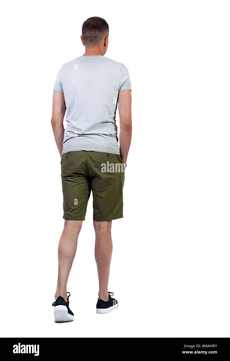Back view of going handsome man in shorts. walking young guy . Rear ...