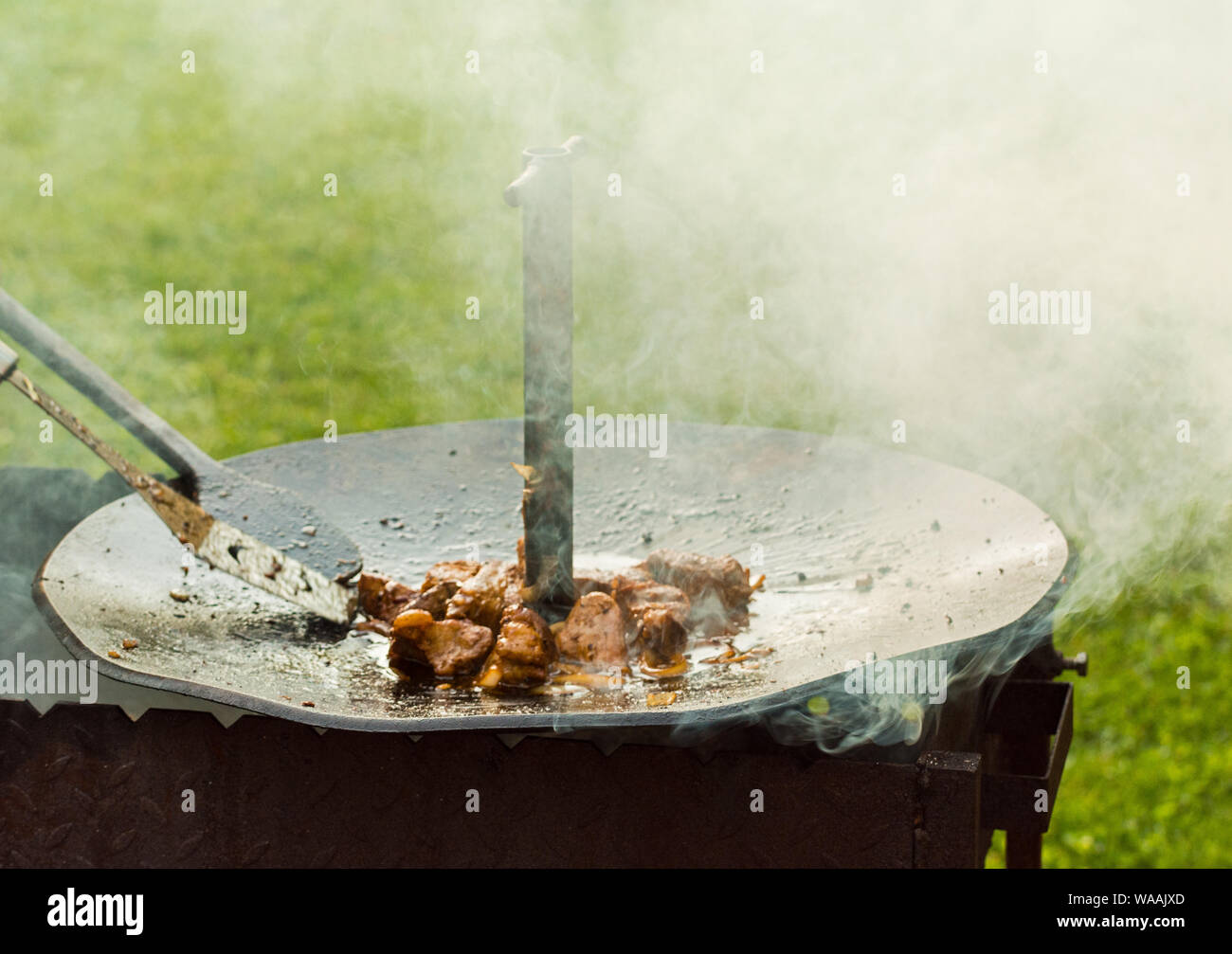 The meat is cooked in a cauldron Stock Photo - Alamy
