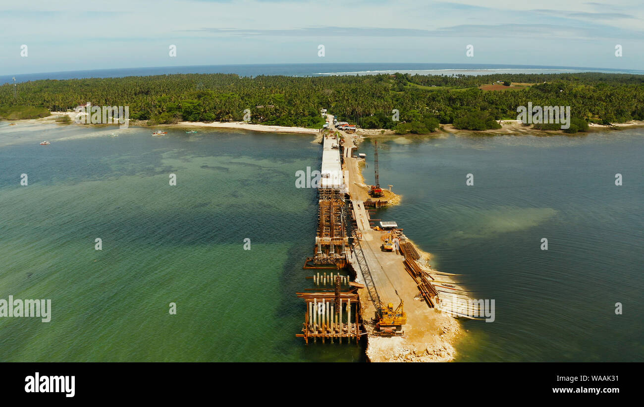Construction of a new bridge over the sea bay on the tropical island of ...