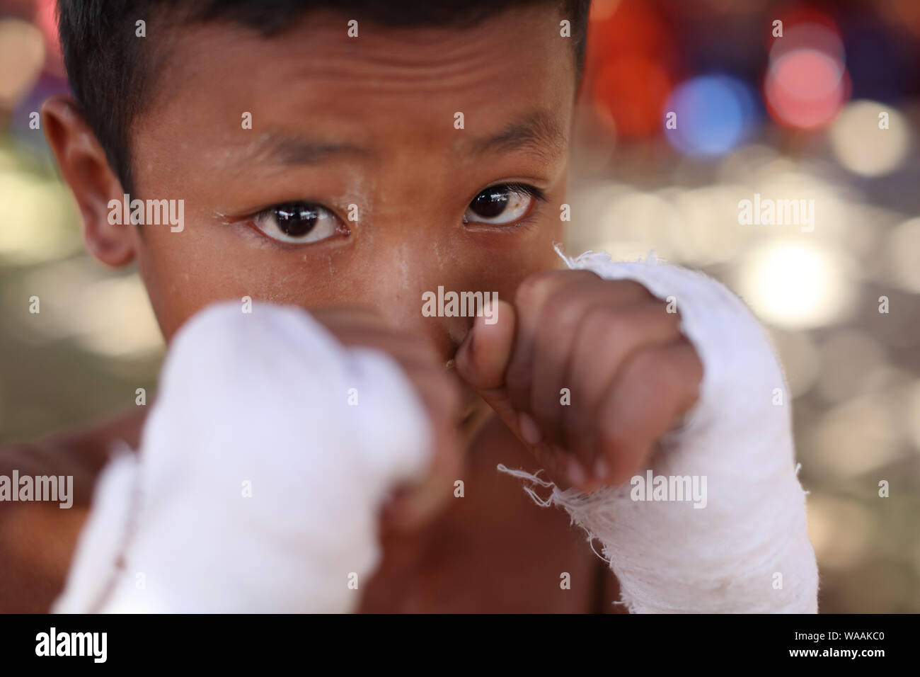 Traditional Lethwei boxer at a rural tournament in a village near Hpa ...