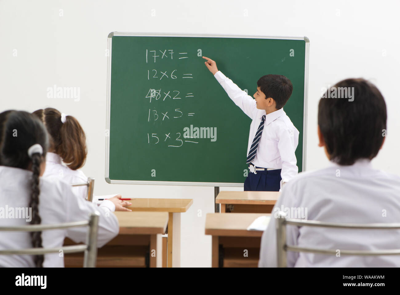 Schoolboy teaching his classmates in a classroom Stock Photo - Alamy