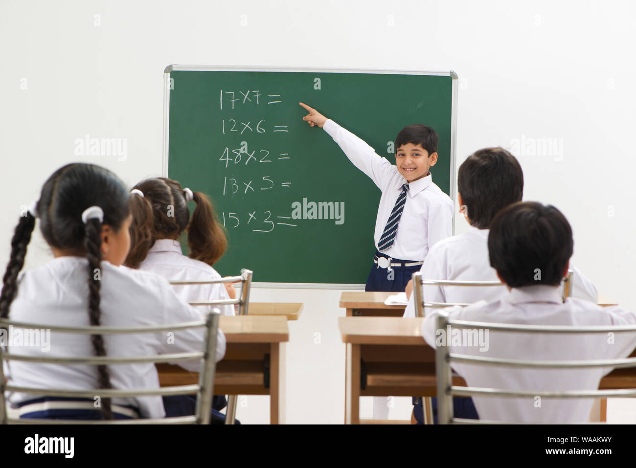 Schoolboy teaching his classmates in a classroom Stock Photo - Alamy