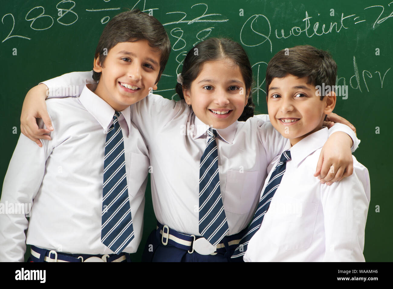 School children standing in front of blackboard Stock Photo - Alamy