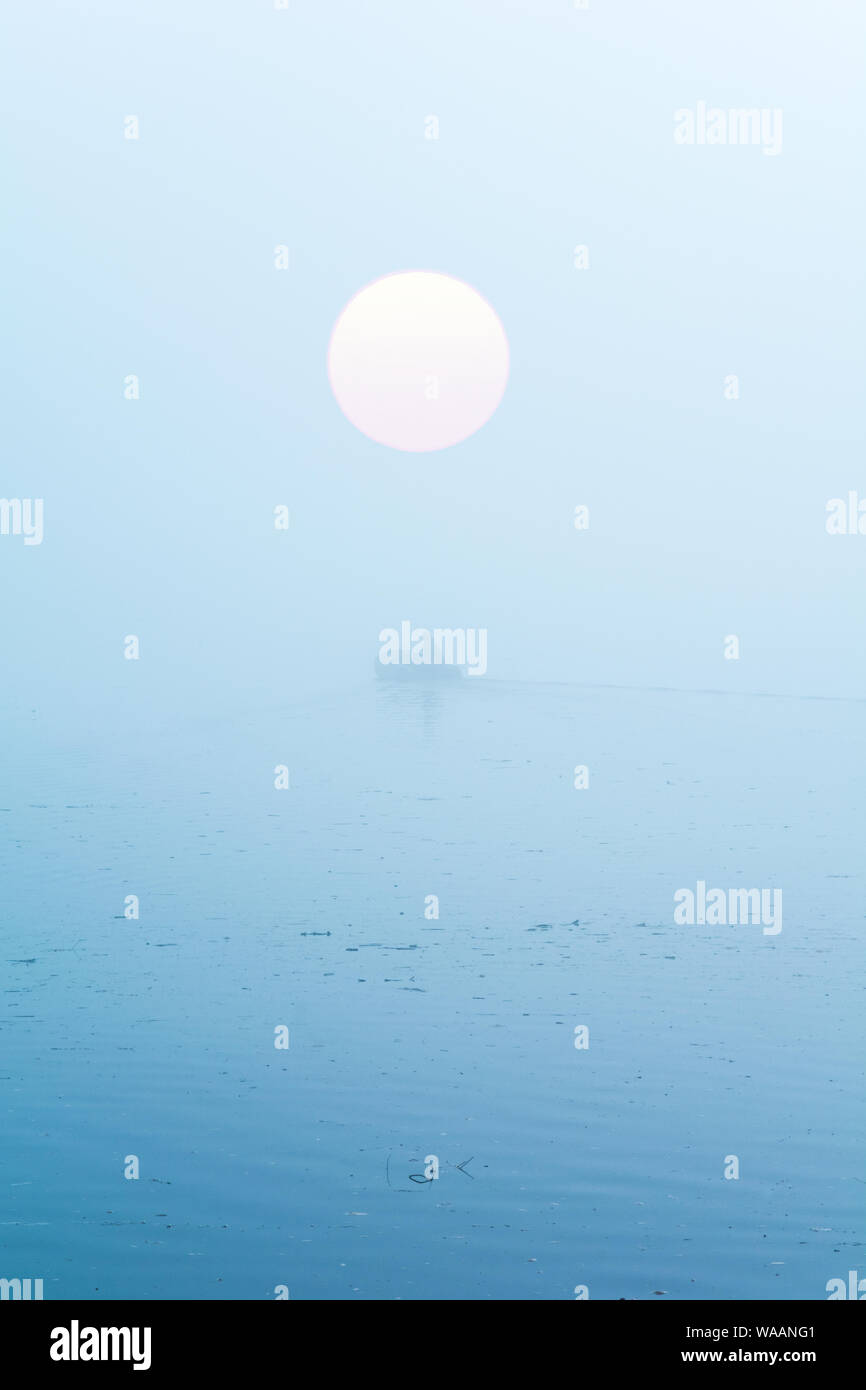 Blue fishing boat in fog hi-res stock photography and images - Alamy