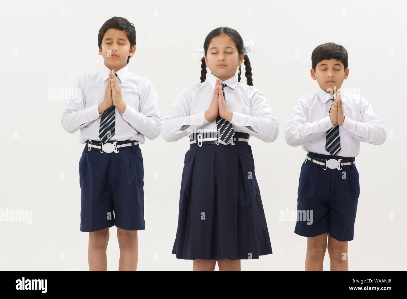 School children praying with hands joined together Stock Photo - Alamy