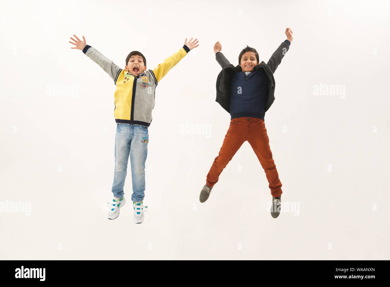 Two children jumping in air Stock Photo - Alamy