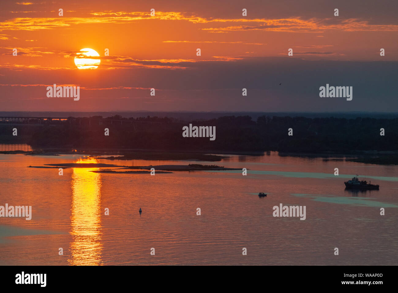 Beautiful reflection of the Sun on water surface. Good evening weather ...