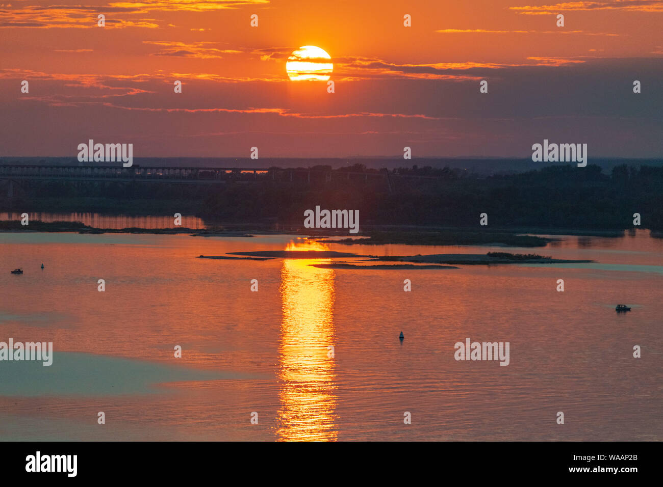 Beautiful reflection of the Sun on water surface. Good evening weather ...