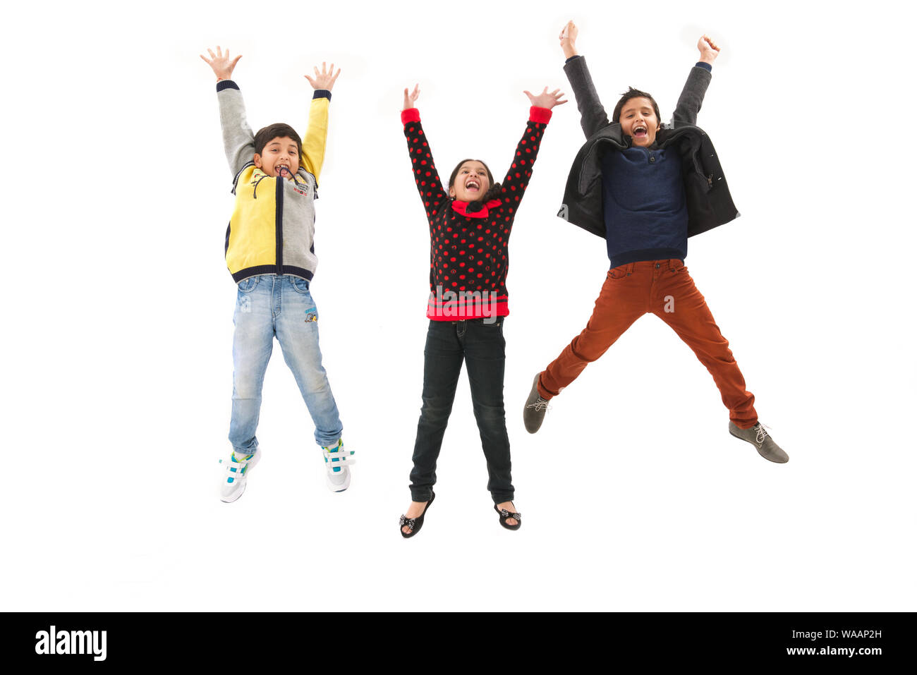 Three children jumping Stock Photo - Alamy