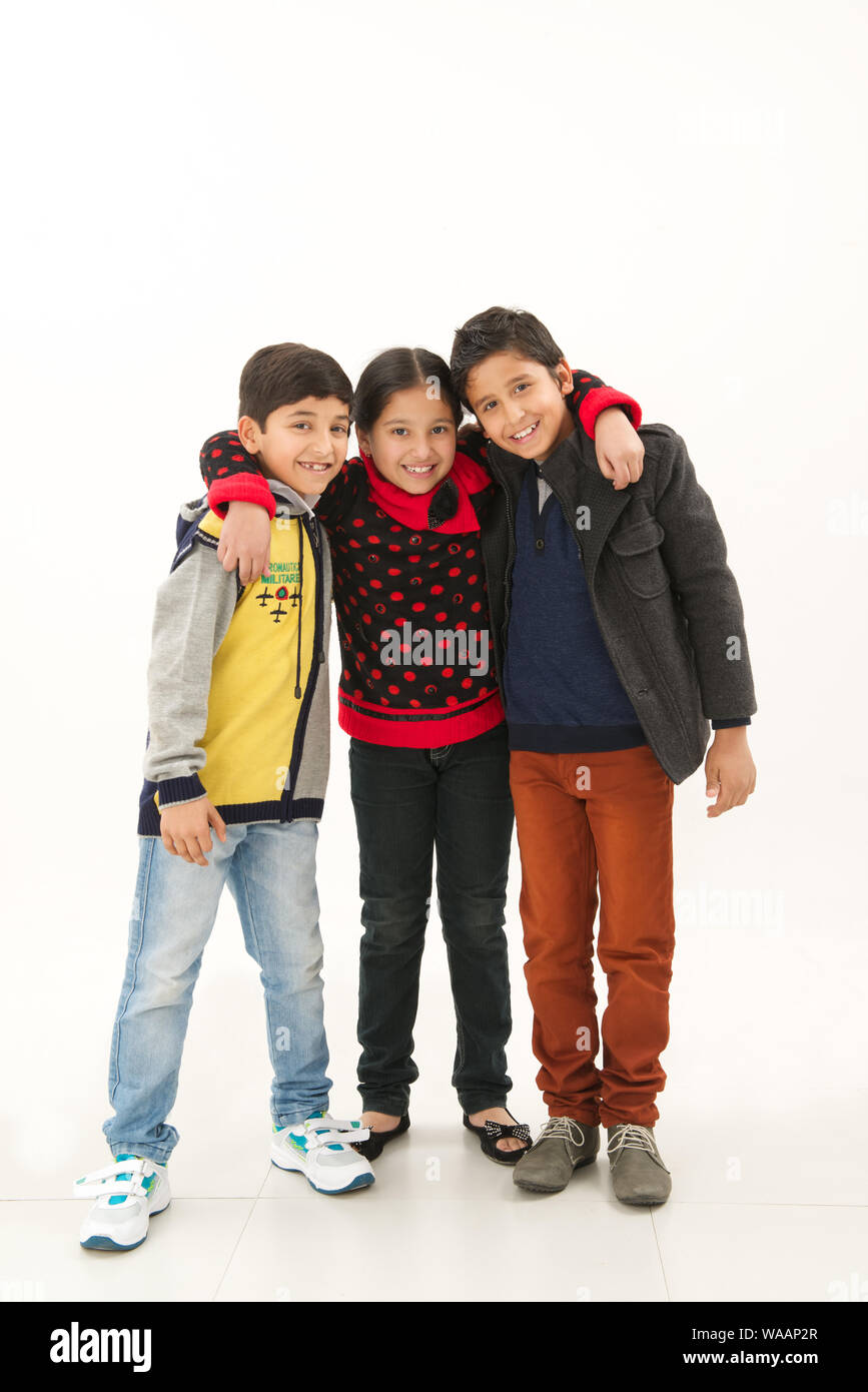 Three friends standing together and smiling Stock Photo - Alamy