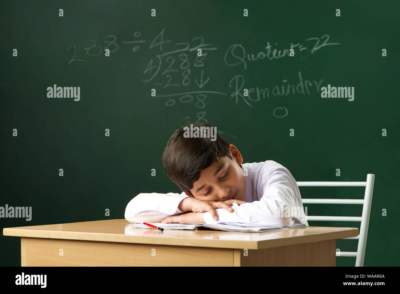 Schoolboy napping in a classroom Stock Photo - Alamy