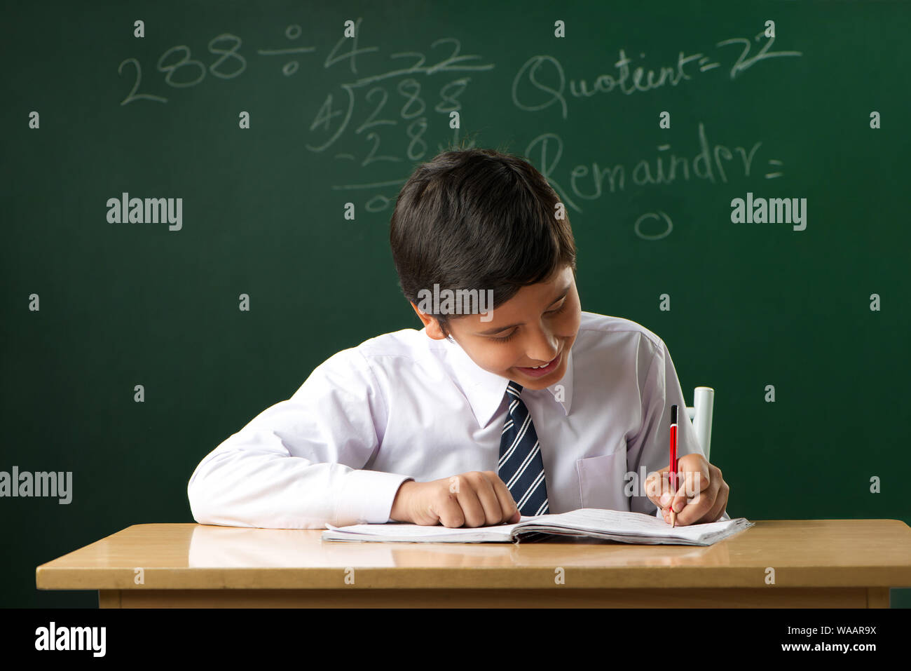 Schoolboy studying in a classroom Stock Photo - Alamy