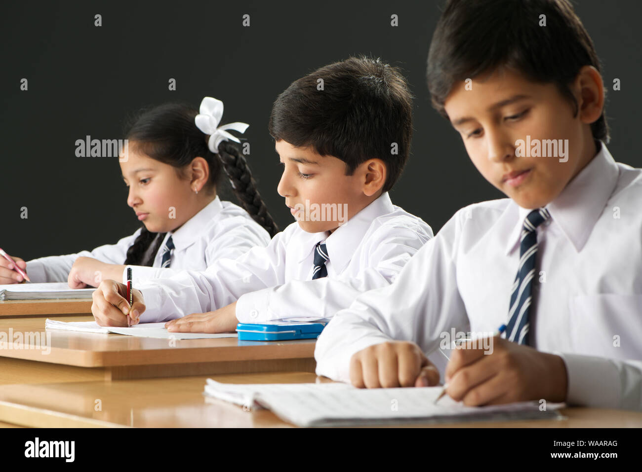School children studying in a classroom Stock Photo - Alamy