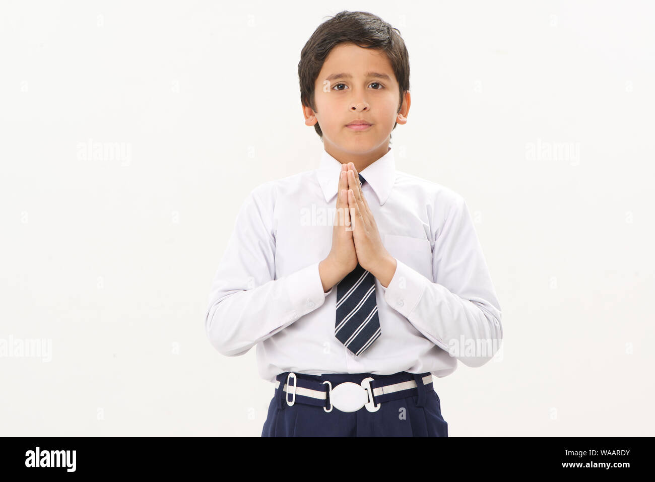 Schoolboy praying with hands joined together Stock Photo - Alamy