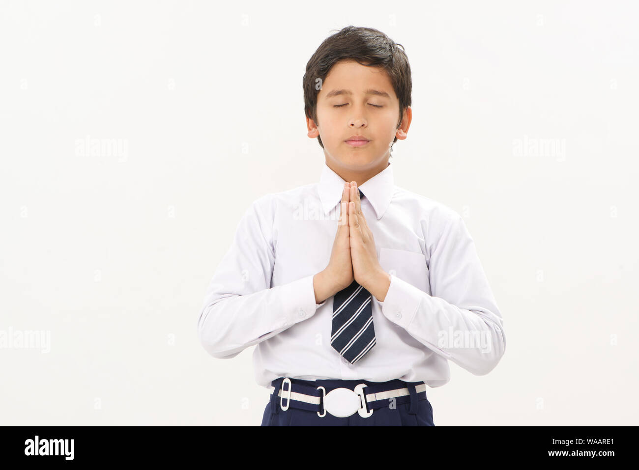 Schoolboy praying with hands joined together Stock Photo - Alamy