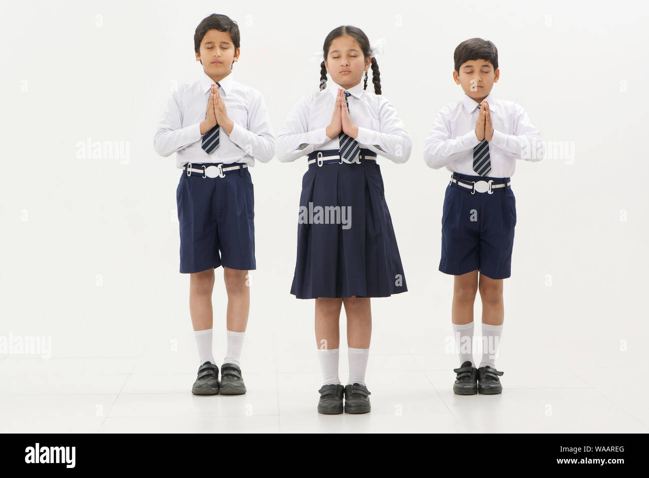 School children praying with hands joined together Stock Photo - Alamy