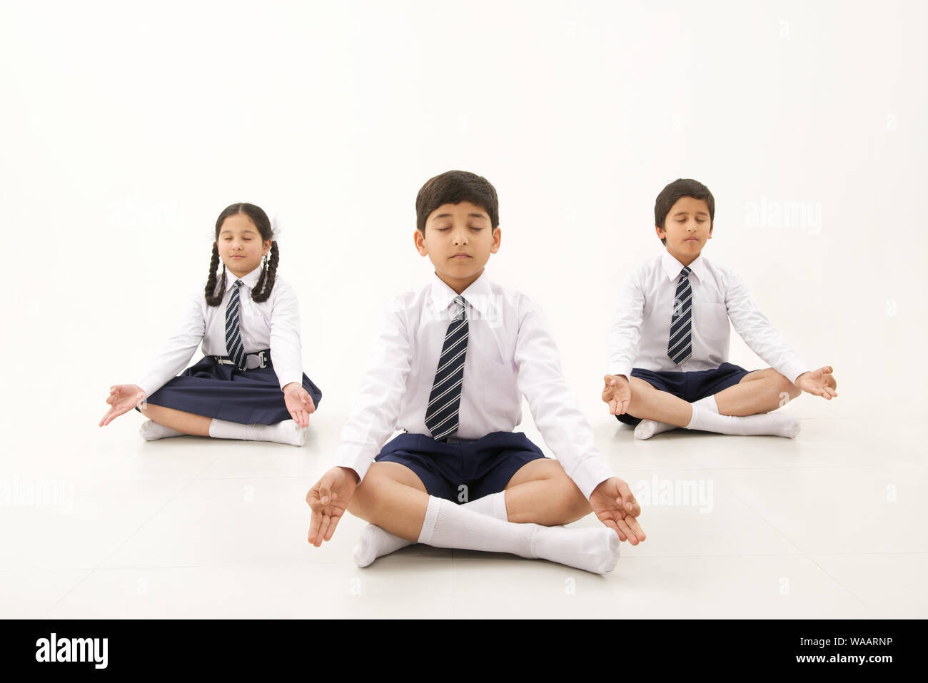 School children sitting in yoga pose Stock Photo - Alamy