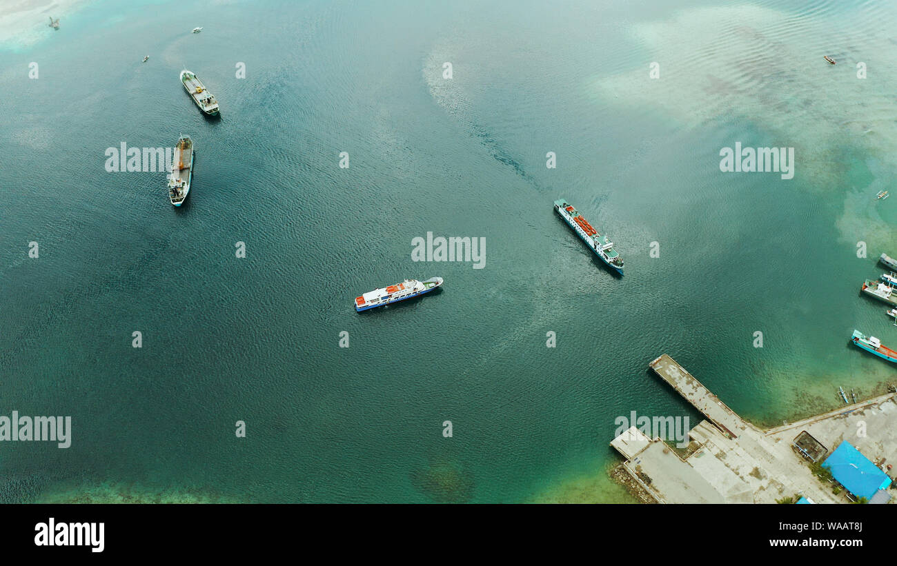 Freight ships and ferries in the bay, top view. Dapa Ferry Terminal ...